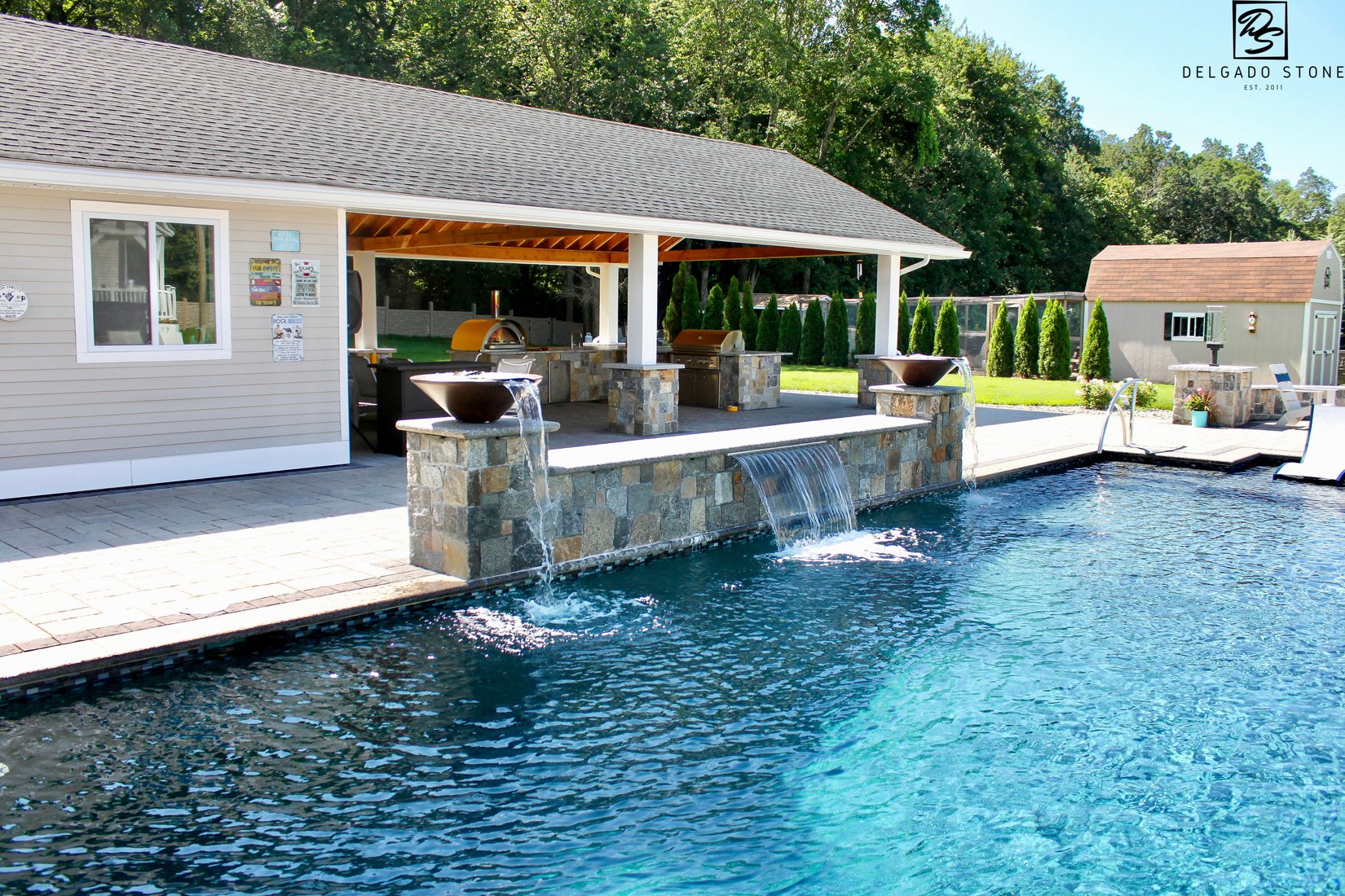 Elevate Your Pool Design with Waterfalls (and Natural Stone)